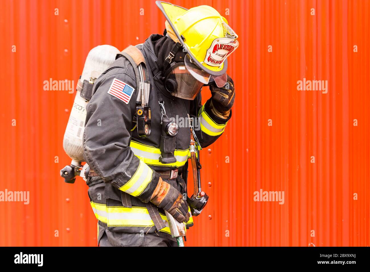 Firefighter looking down, standing in front of the red Worcester Fire ...