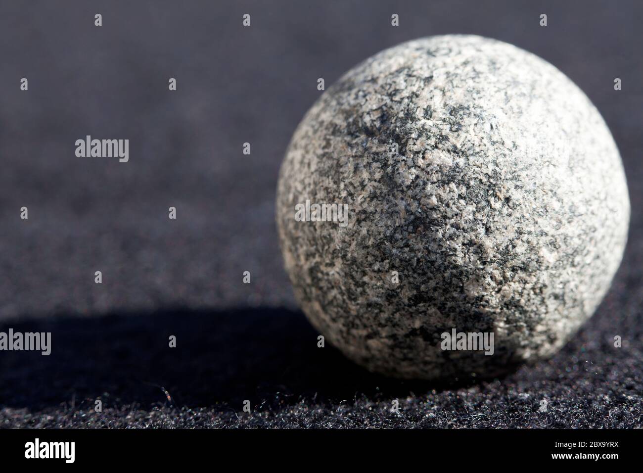Granite stone spherical, round in a hole. Black and white pattern Stock ...