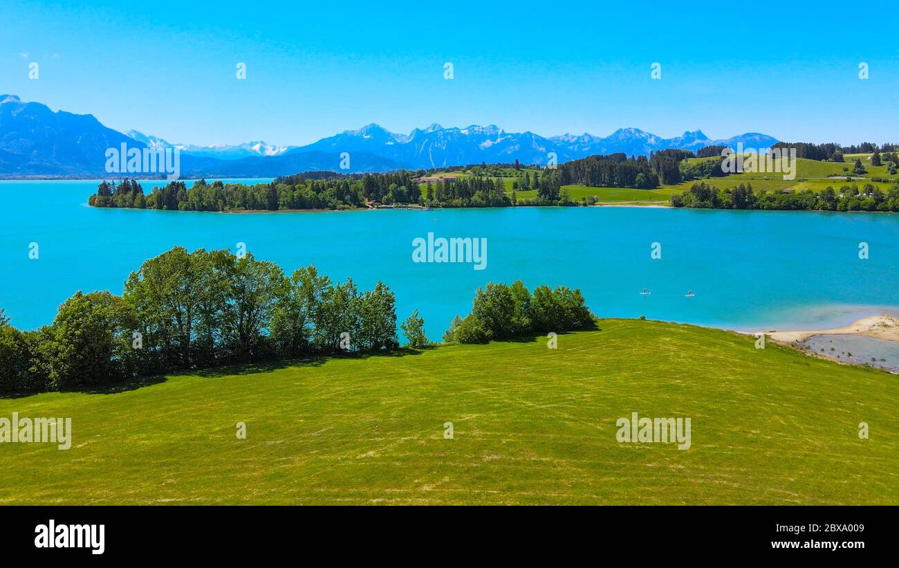 Aerial view over Lake Forggensee at the city of Fuessen in Germany ...