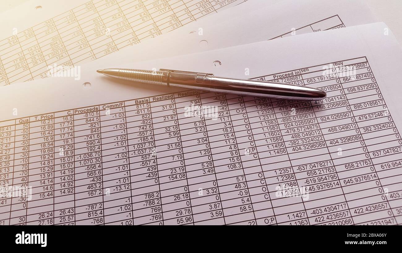 Pen on financial report figures. Balancing the Accounts business ...