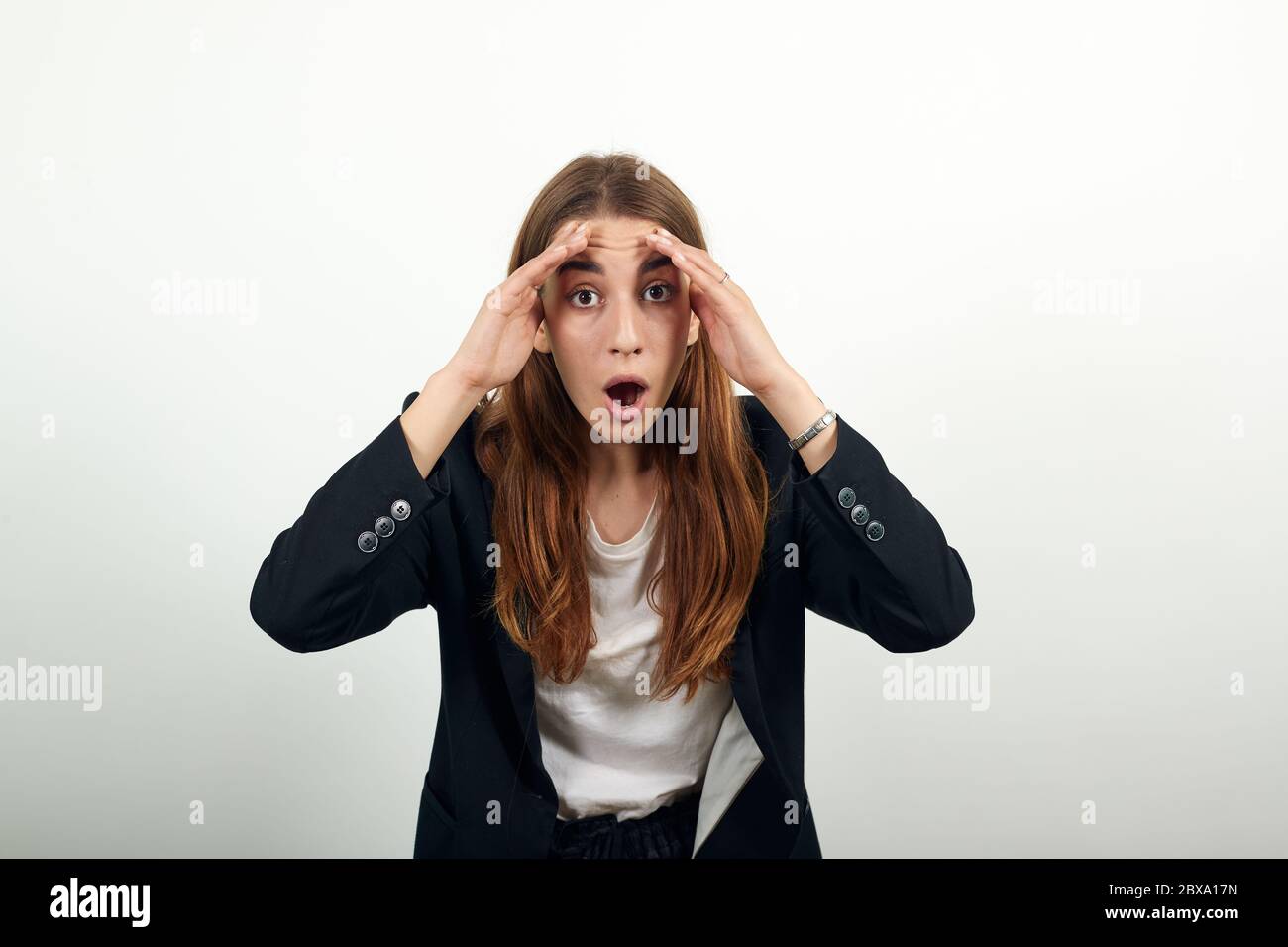 Surprised woman holding palms of her hands near eyes, state shock ...