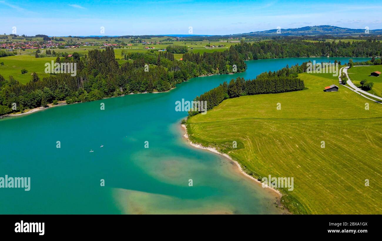 Aerial view over Lake Forggensee at the city of Fuessen in Germany ...