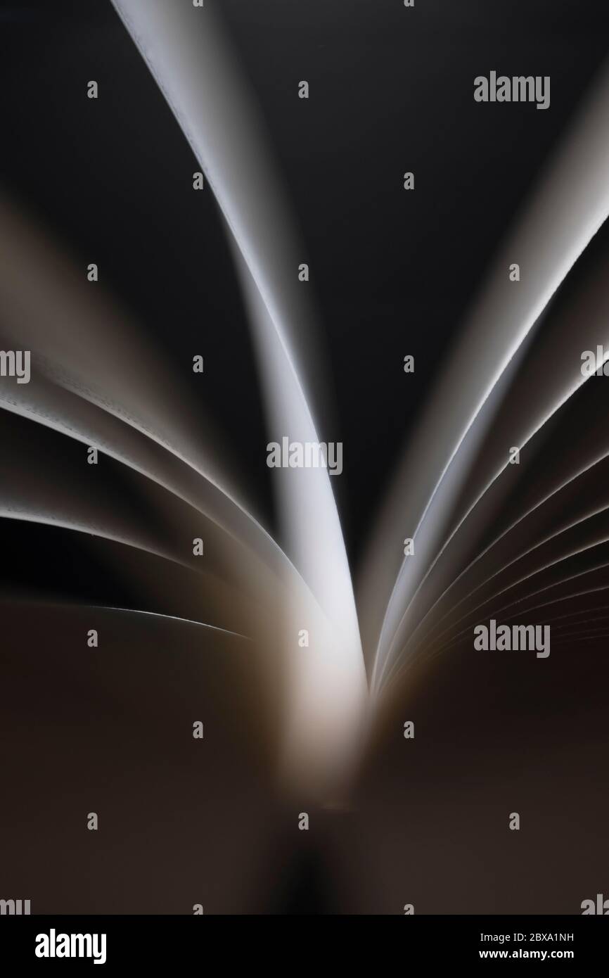 Composition of an open book with narrow depth of field on black ...