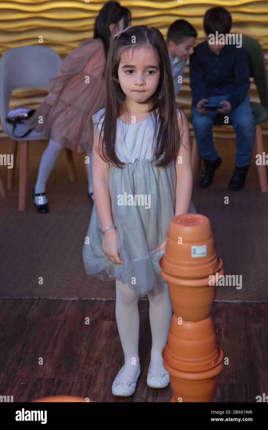 children play a race to stack a bowl on top of each other. Kids Playing ...