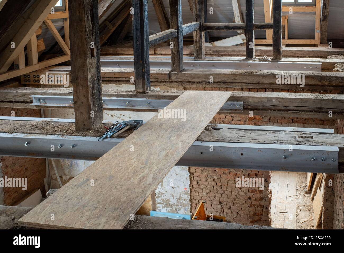 in an old building old wooden beams are reinforced with steel beams ...
