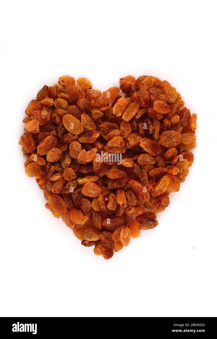 A scattering of organic raisins in the form of heart - isolated object ...