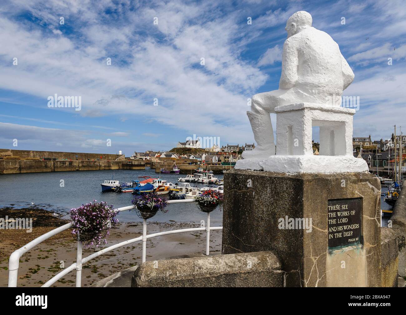 Findochty village on the Moray Firth with dominant memorial statue to ...