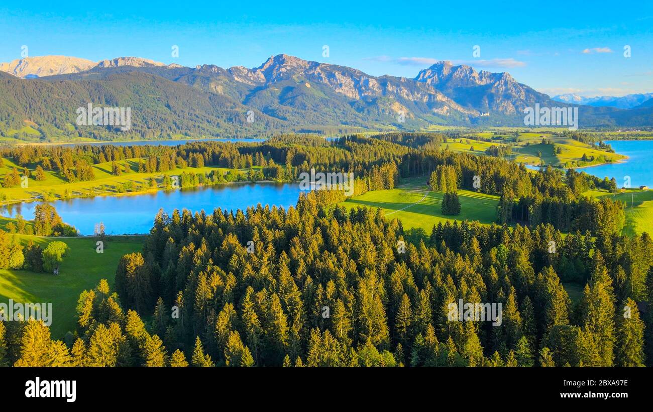 Aerial view over Lake Forggensee at the city of Fuessen in Germany ...