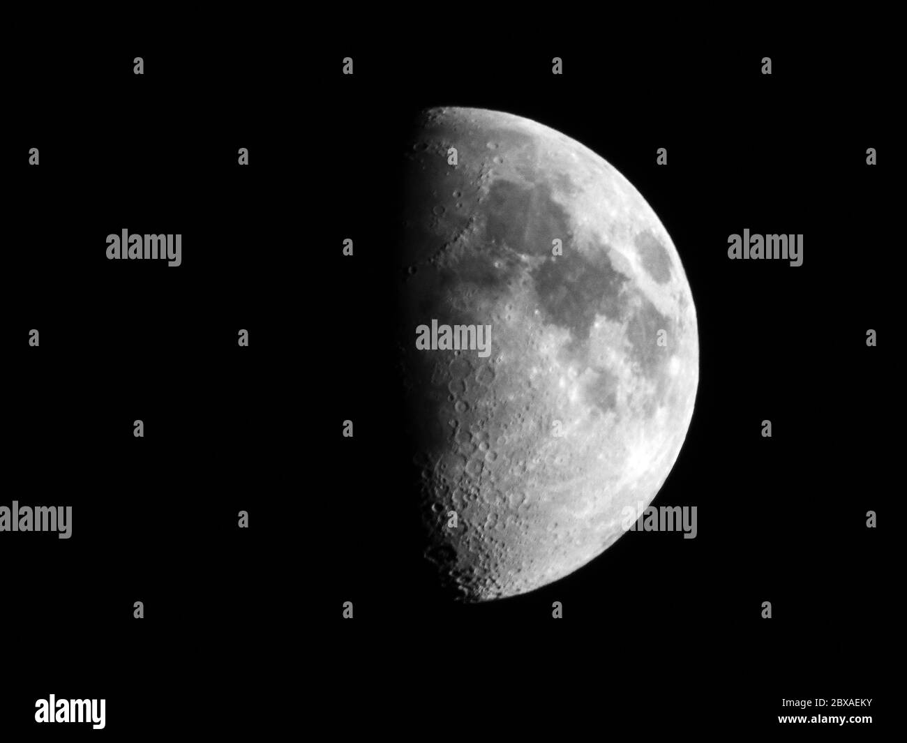 First quarter, half moon, in a dark sky Stock Photo - Alamy