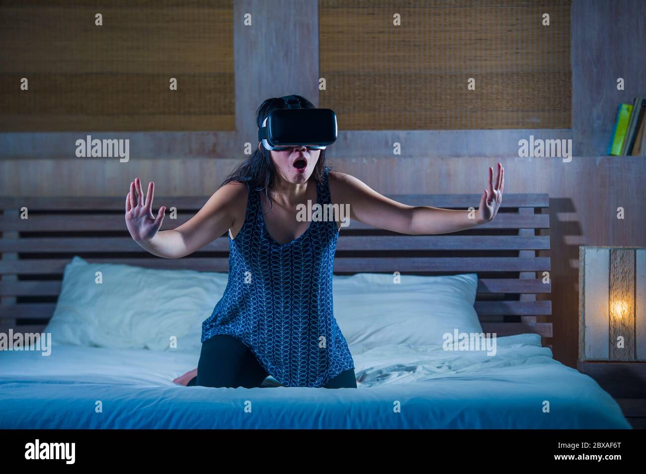 young attractive excited and happy girl wearing VR virtual reality ...