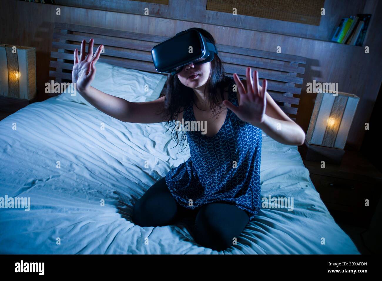 young attractive excited and happy girl wearing VR virtual reality ...