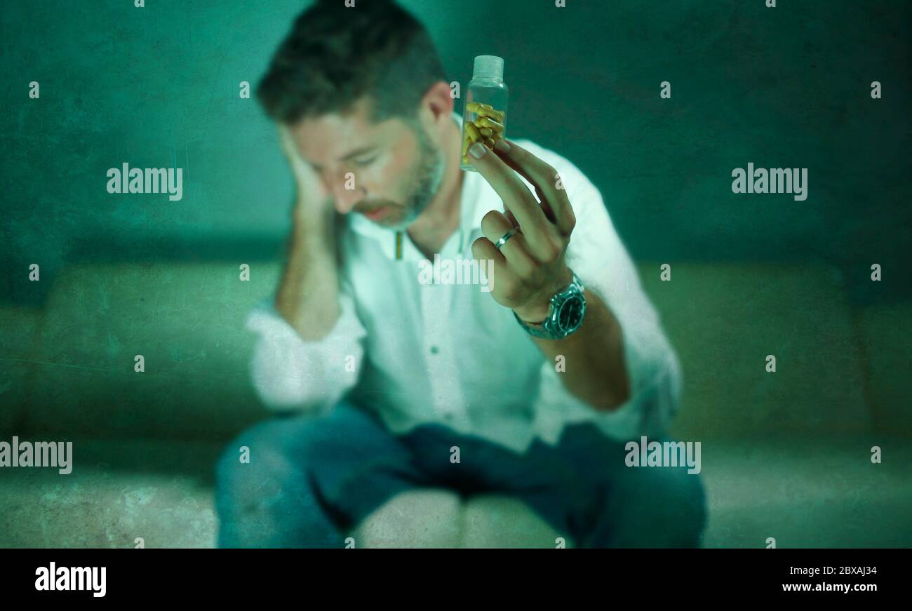 dramatic portrait of young attractive depressed and wasted pills addict ...