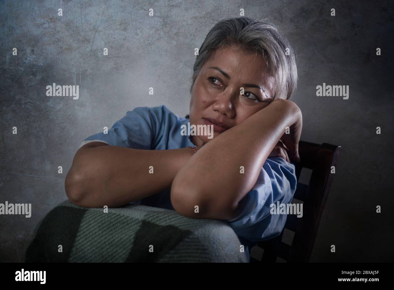 dramatic portrait of attractive sad and depressed mature woman with ...