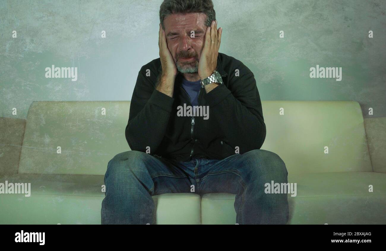 dramatic portrait of young attractive depressed and sad shady man at ...