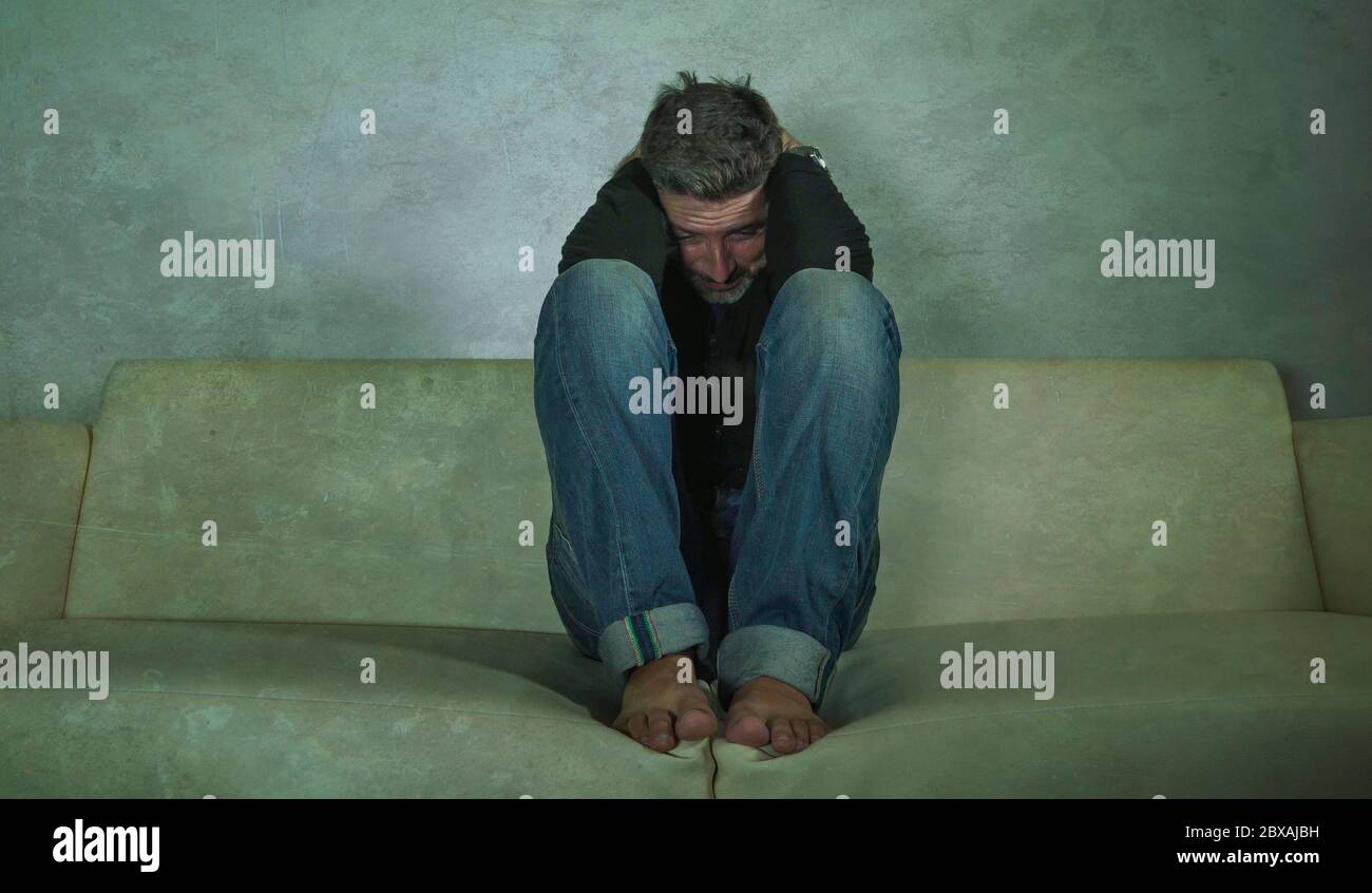 dramatic portrait of young attractive depressed and sad shady man at ...