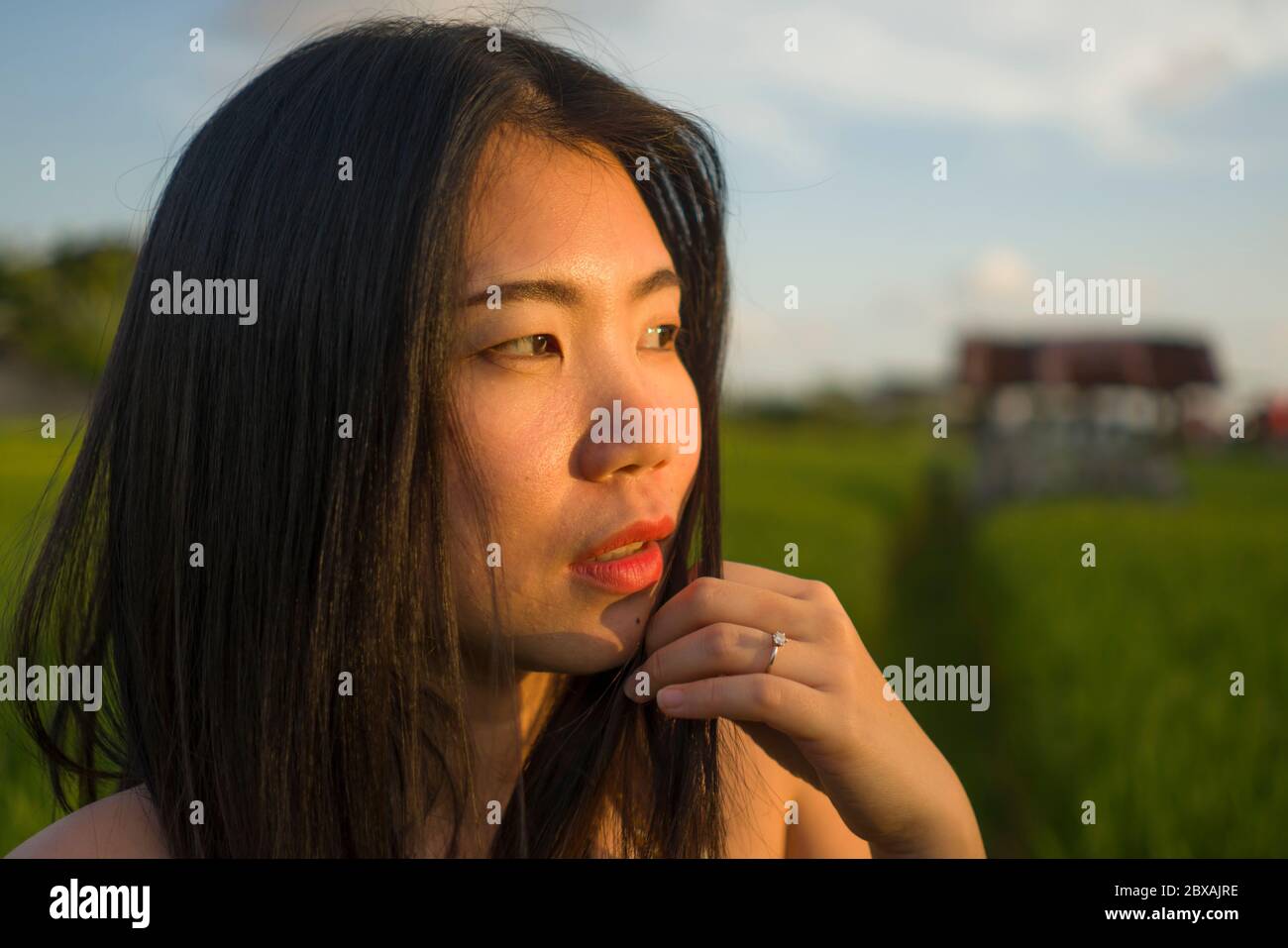 young happy and beautiful Asian woman enjoying nature at rice field ...