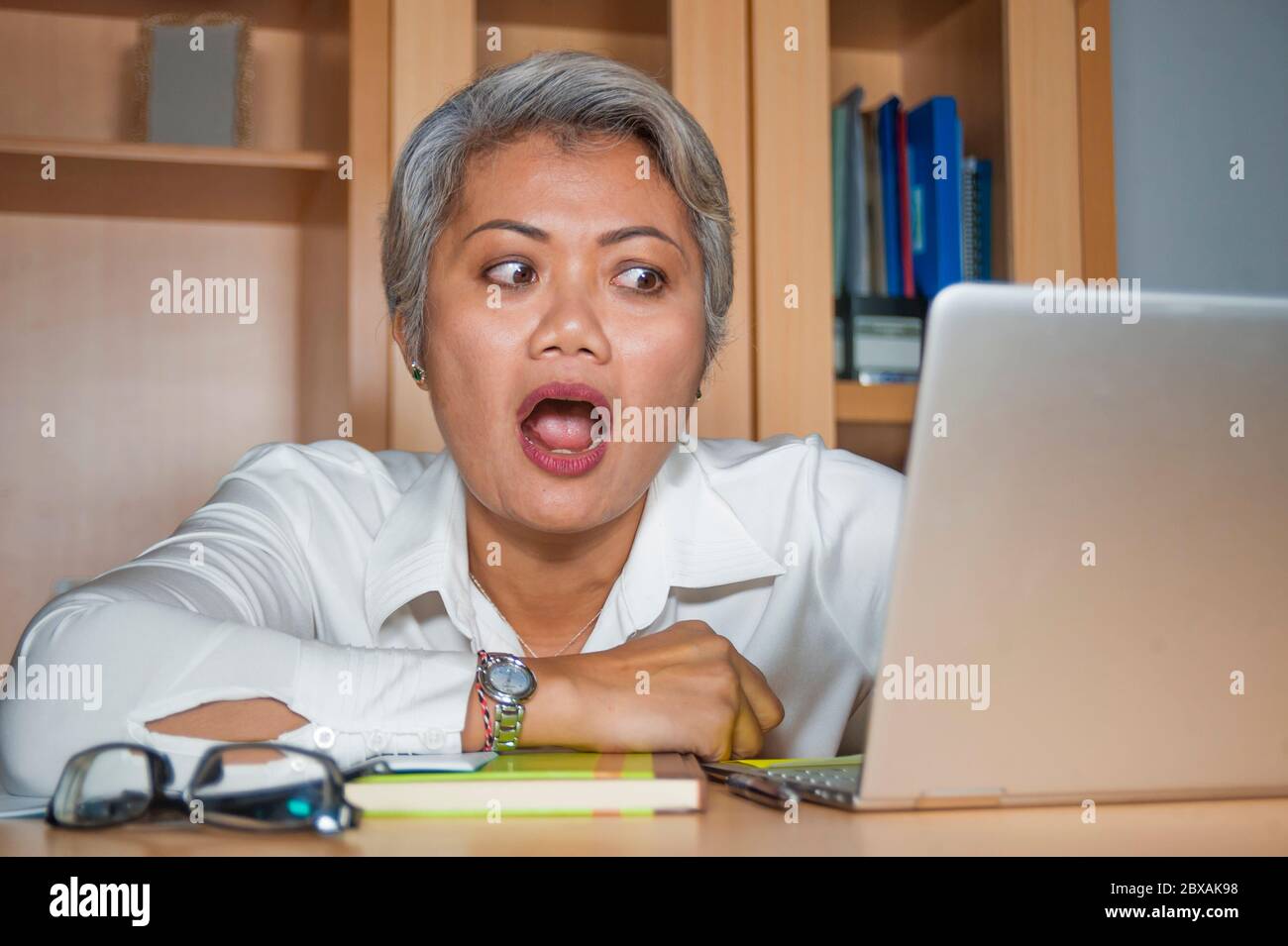 Attractive desperate and stressed middle aged Asian woman screaming ...
