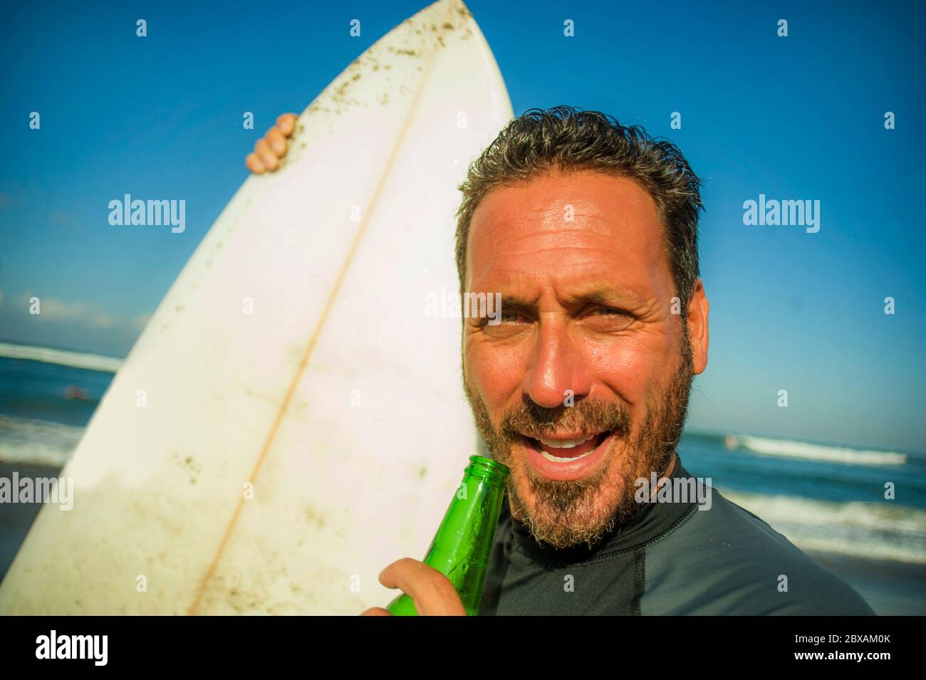 closeup portrait of handsome and attractive surfer man in neoprene ...