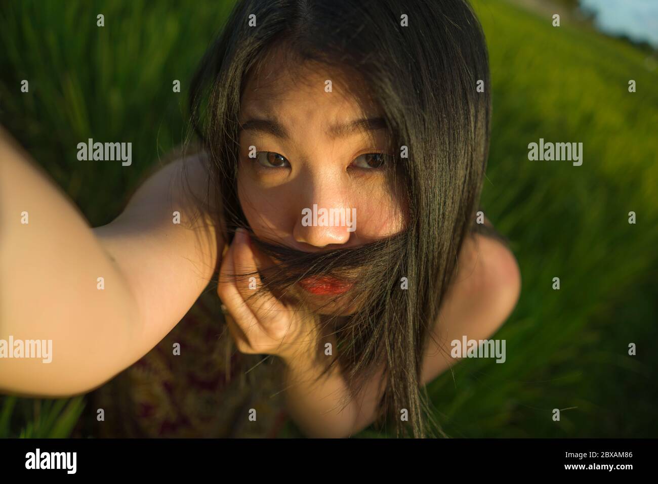 Young Happy And Beautiful Asian Woman Taking Selfie Photo Outdoors