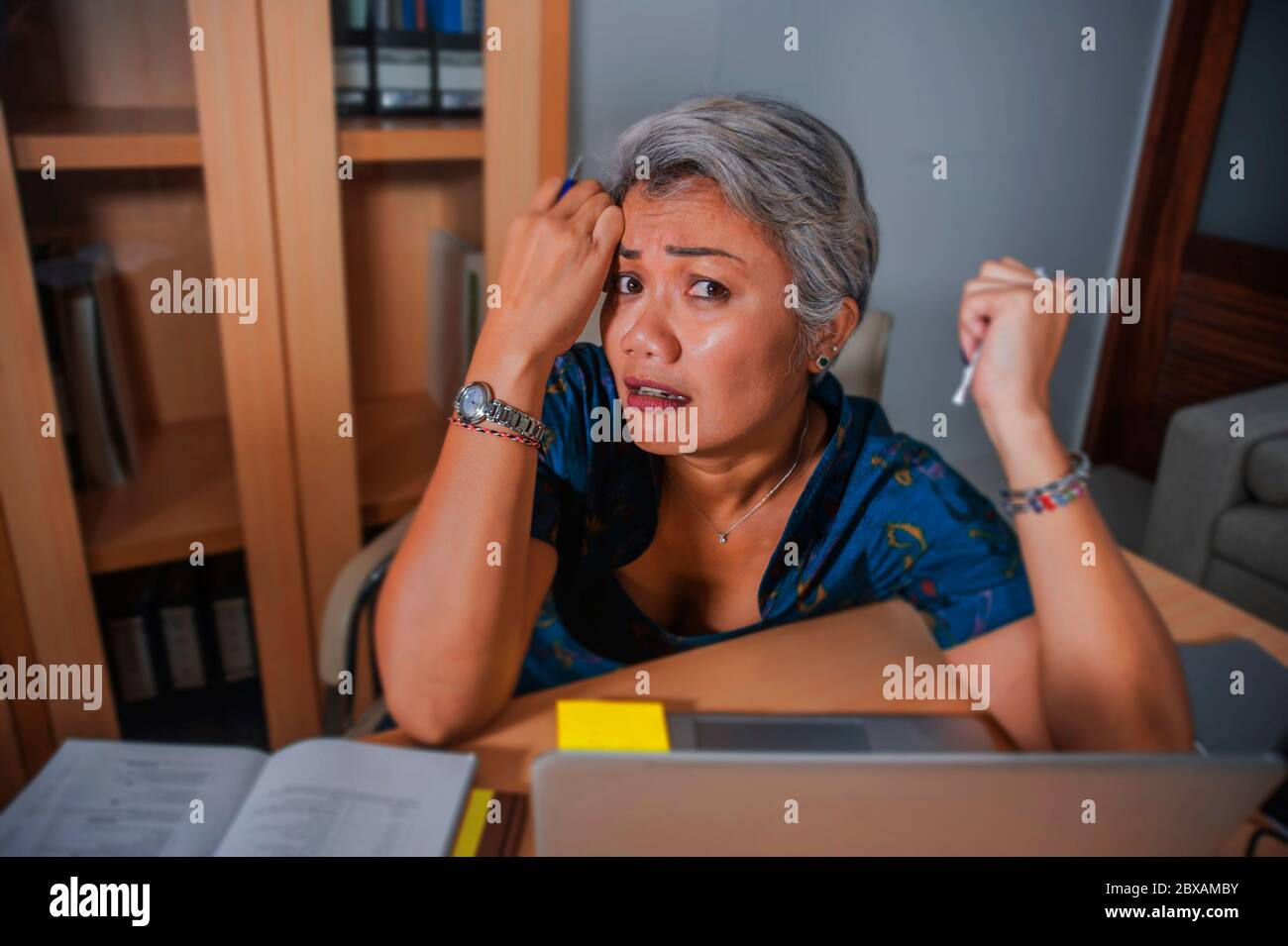 expressive portrait of attractive stressed and overworked Asian woman ...