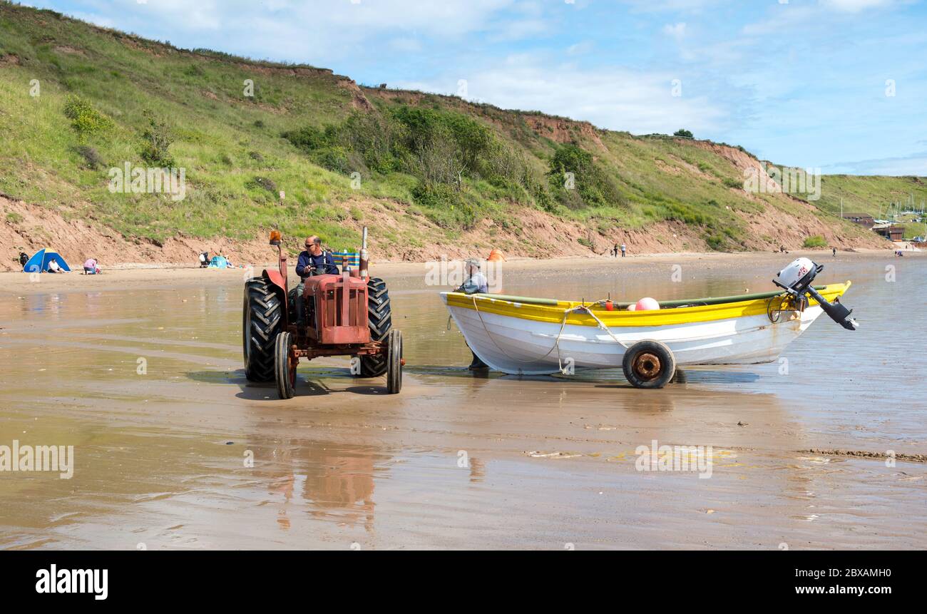 A tractor helping to launch a traditional Yorkshire Cobble open fishing ...
