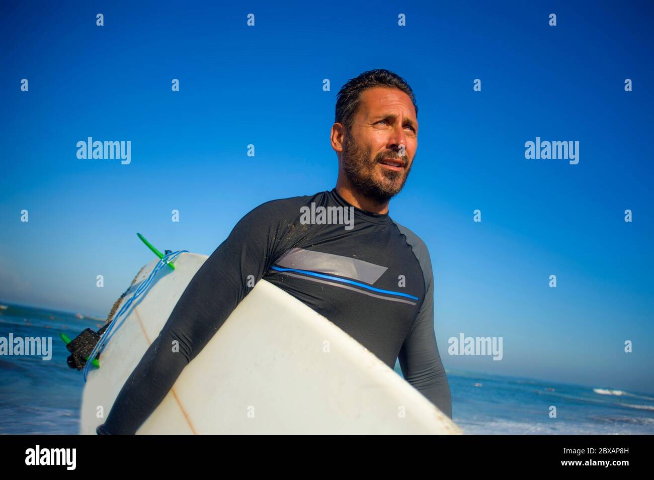 lifestyle portrait of attractive and cool surfer man 3os to 40s in ...