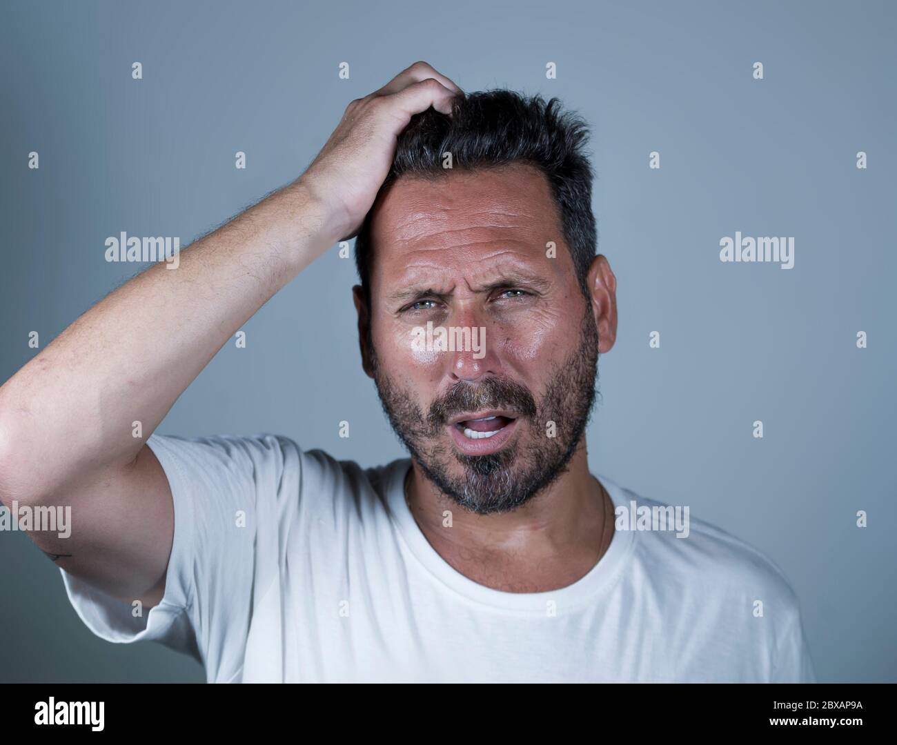dramatic portrait of young attractive worried and stressed man with his ...