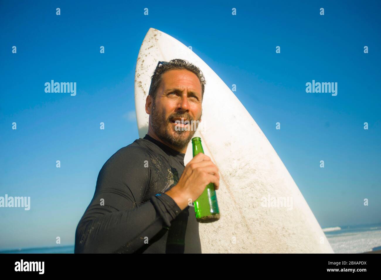 lifestyle portrait of attractive and happy surfer man 3os to 40s in ...