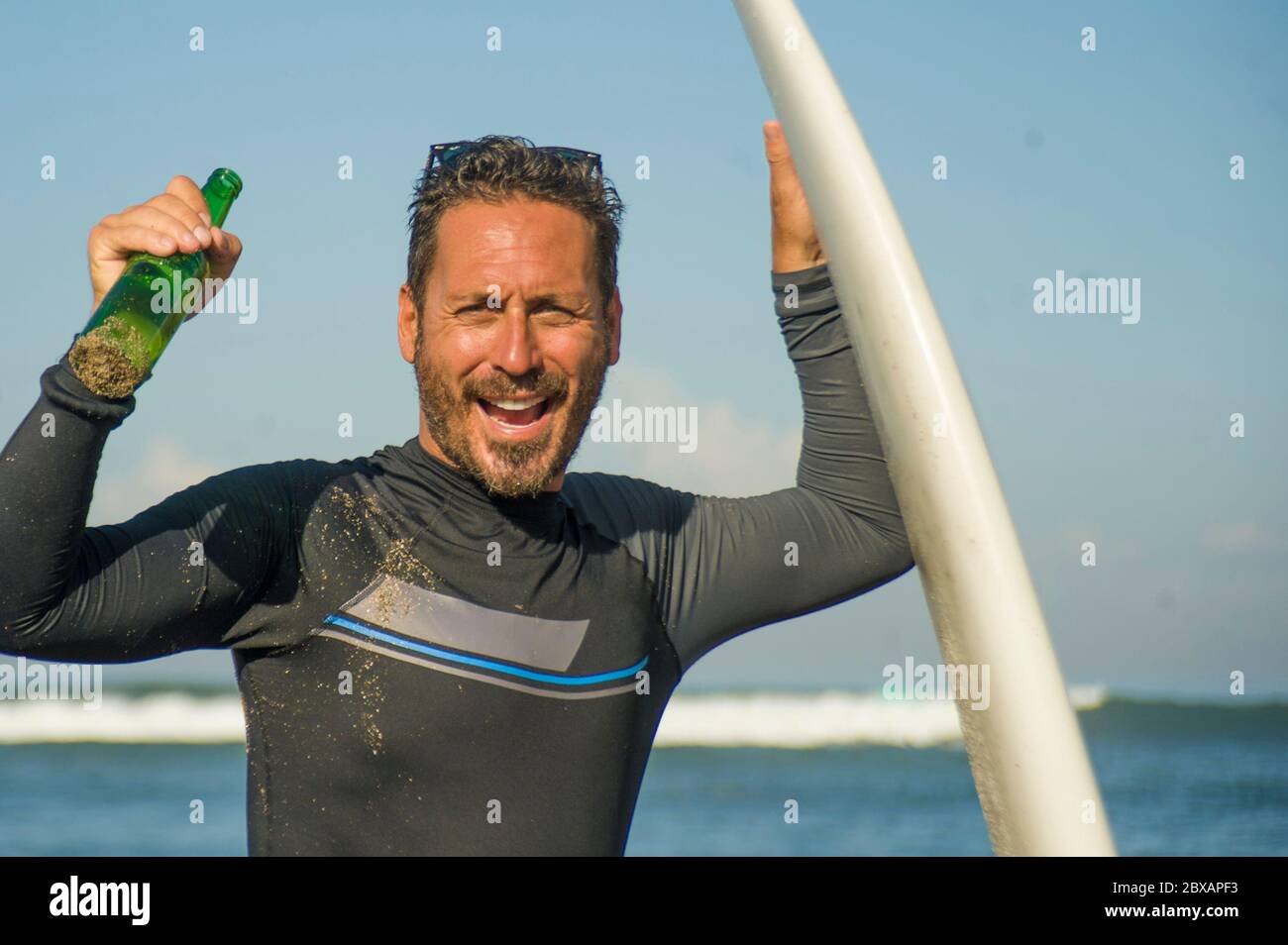 lifestyle portrait of attractive and happy surfer man 3os to 40s in ...