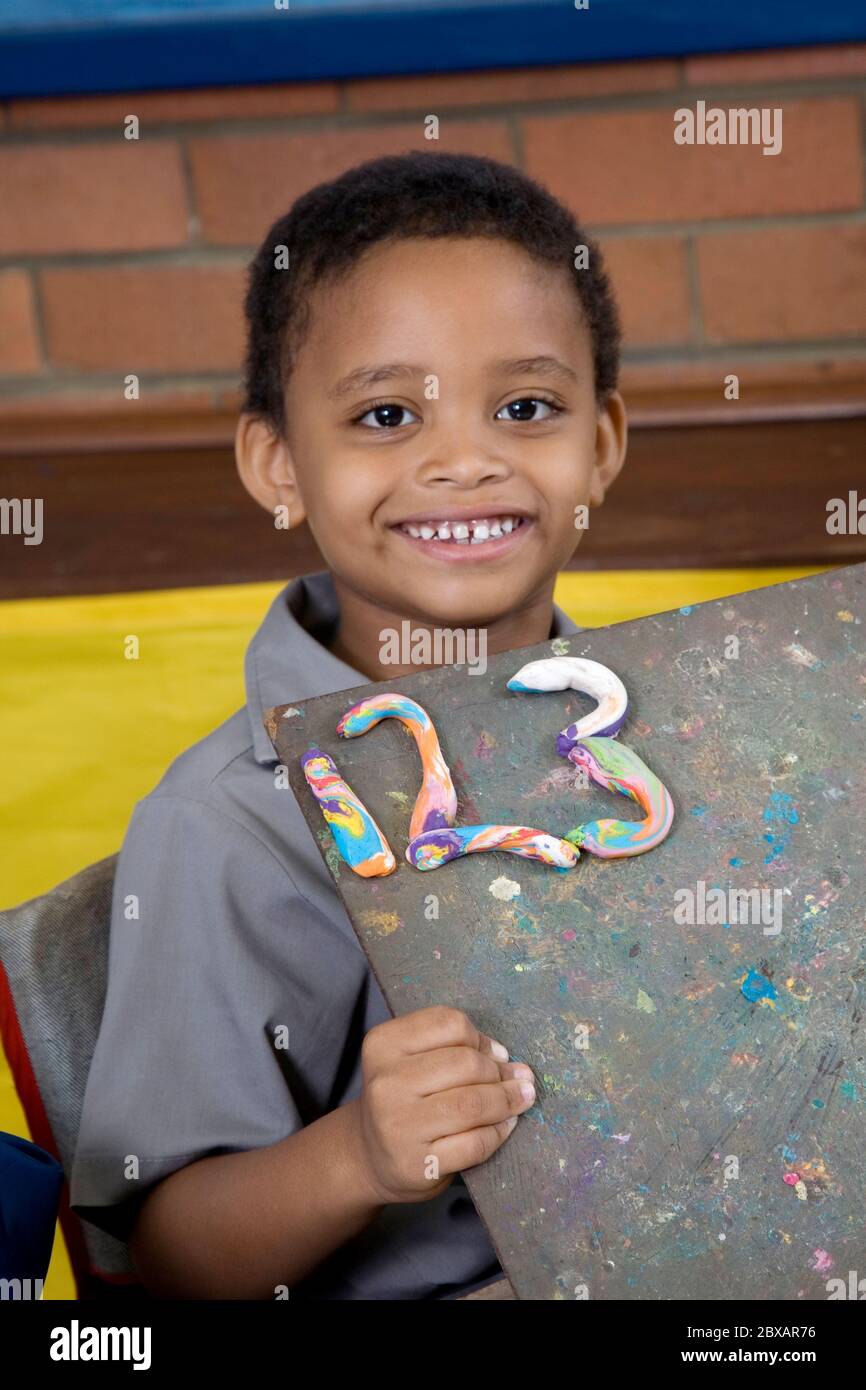 Boy making numbers out of clay Stock Photo - Alamy