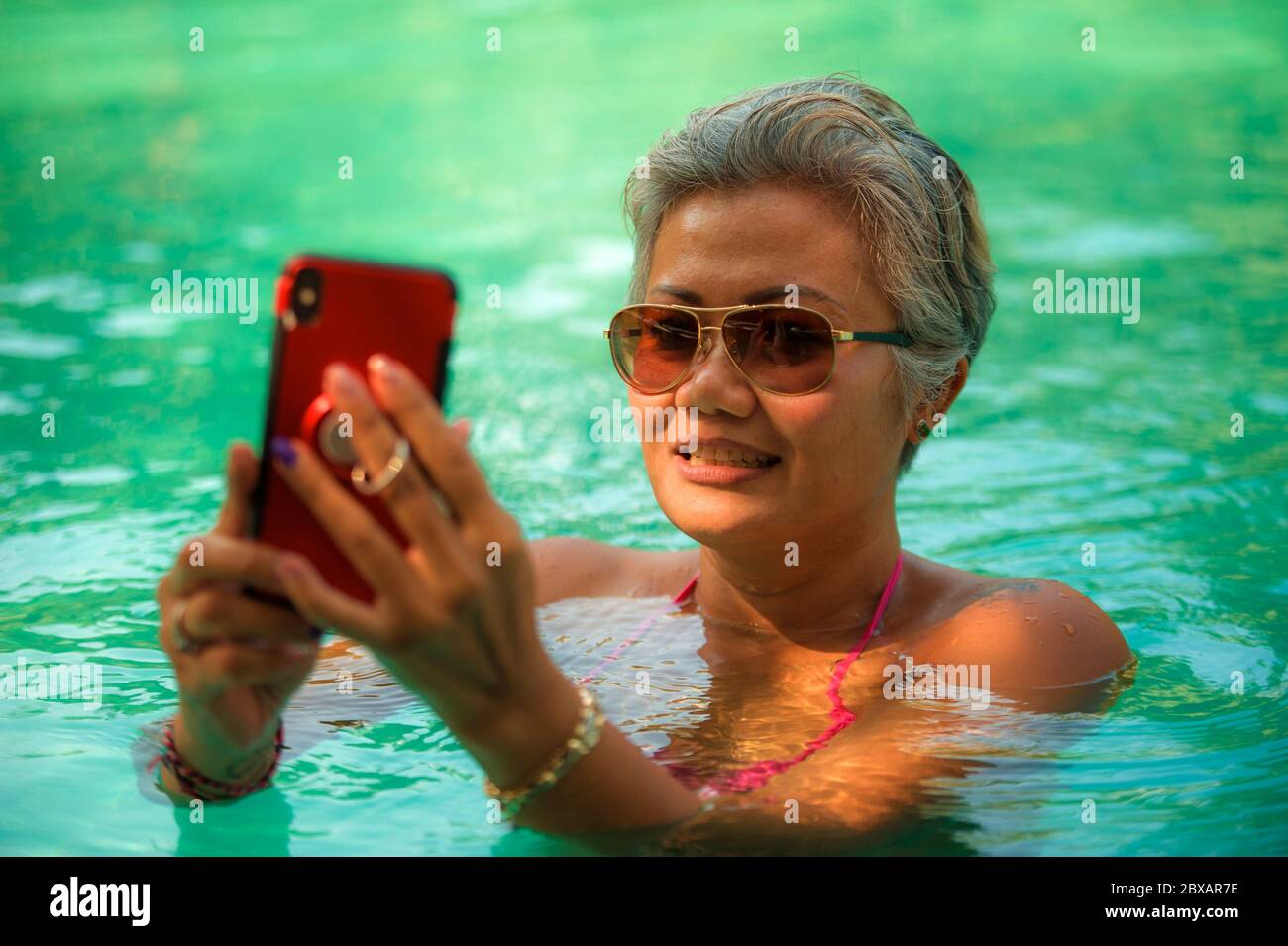 Attractive And Happy Middle Aged Asian Indonesian Woman In Bikini