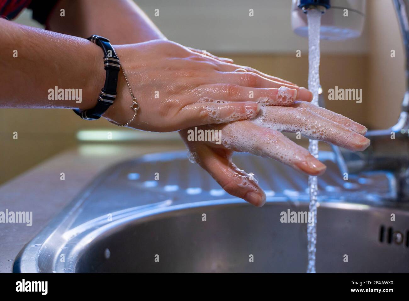 Washing hands properly. Hygiene concept. Rubbing back of hand with soap ...