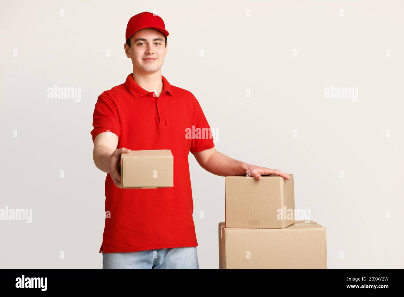 Issuance of parcels at post office. Courier holds out box and puts his ...