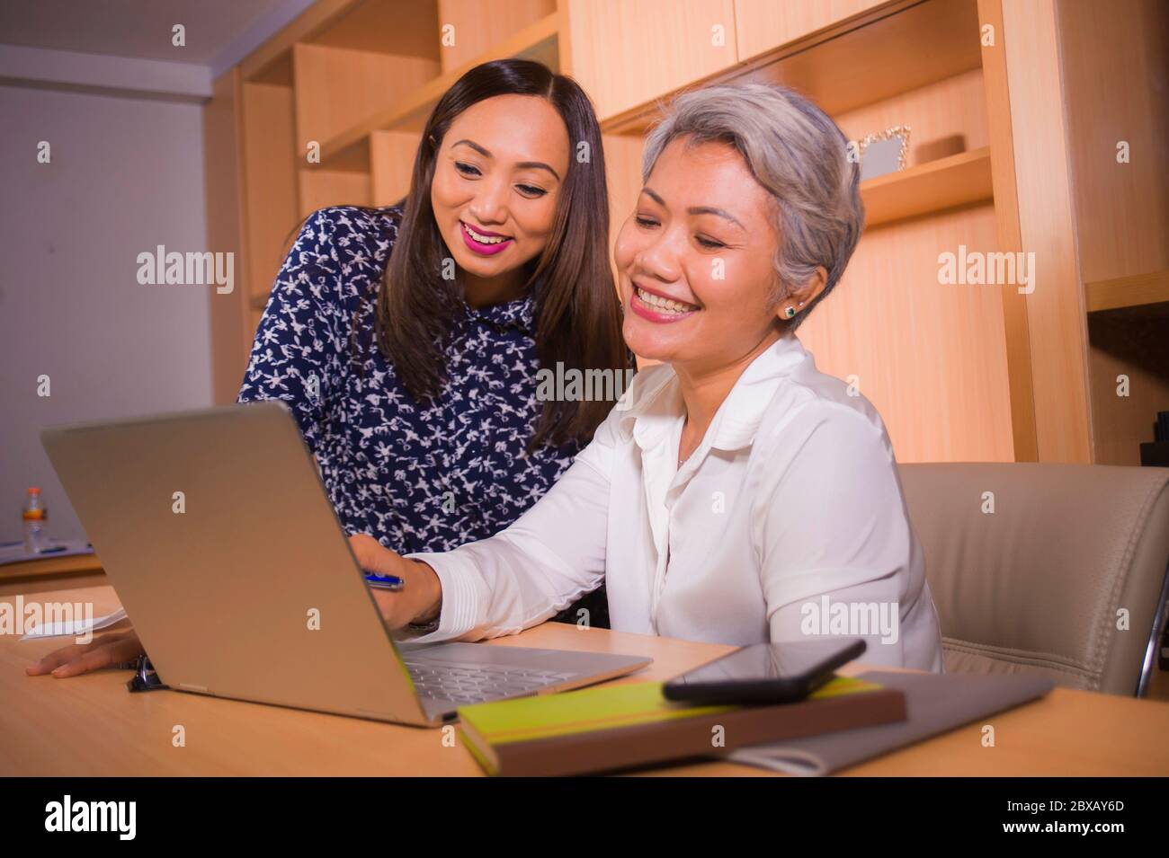 natural lifestyle portrait of two business partners or work colleagues ...