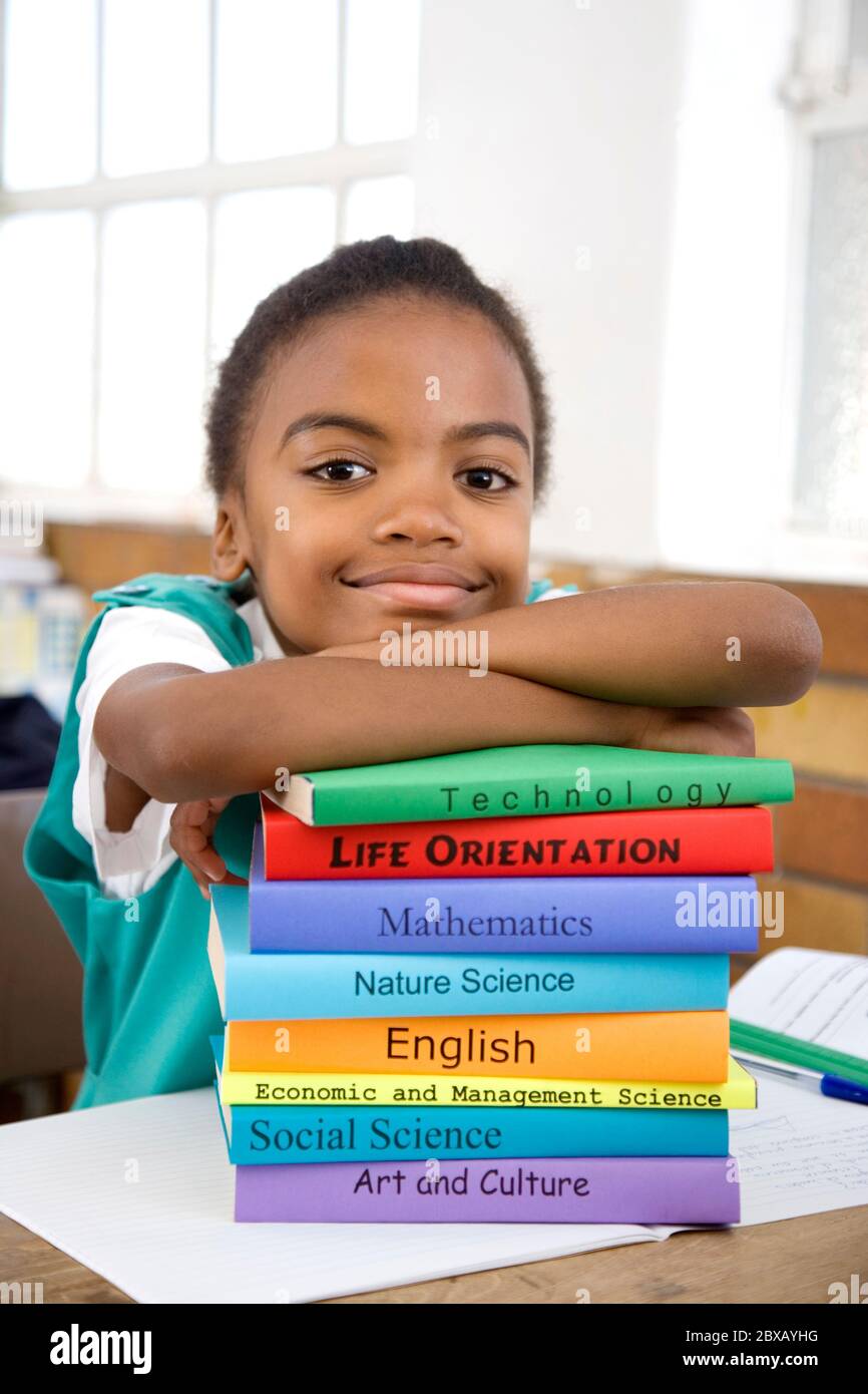 Girl with books in class Stock Photo - Alamy