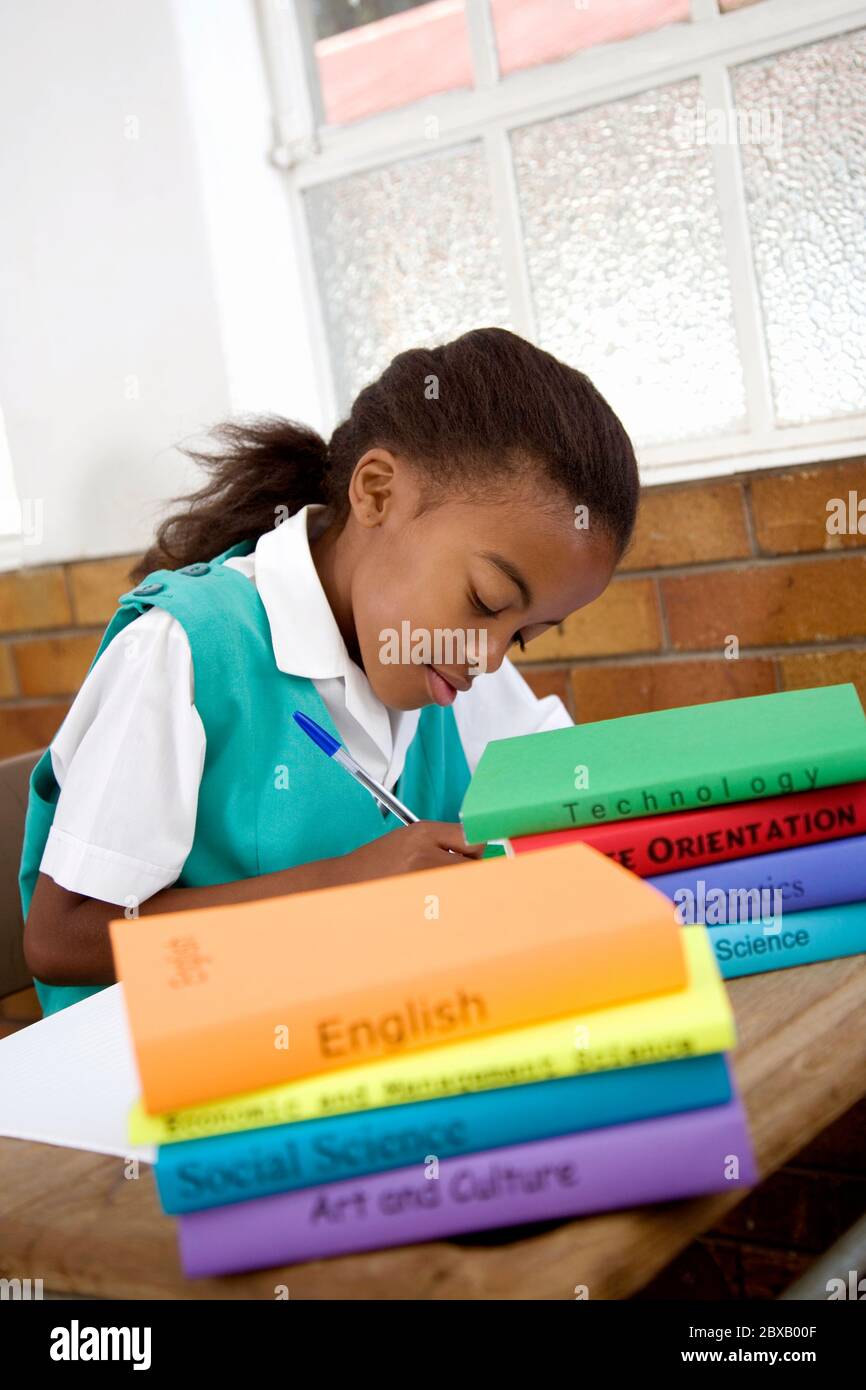 Girl with books in class Stock Photo - Alamy