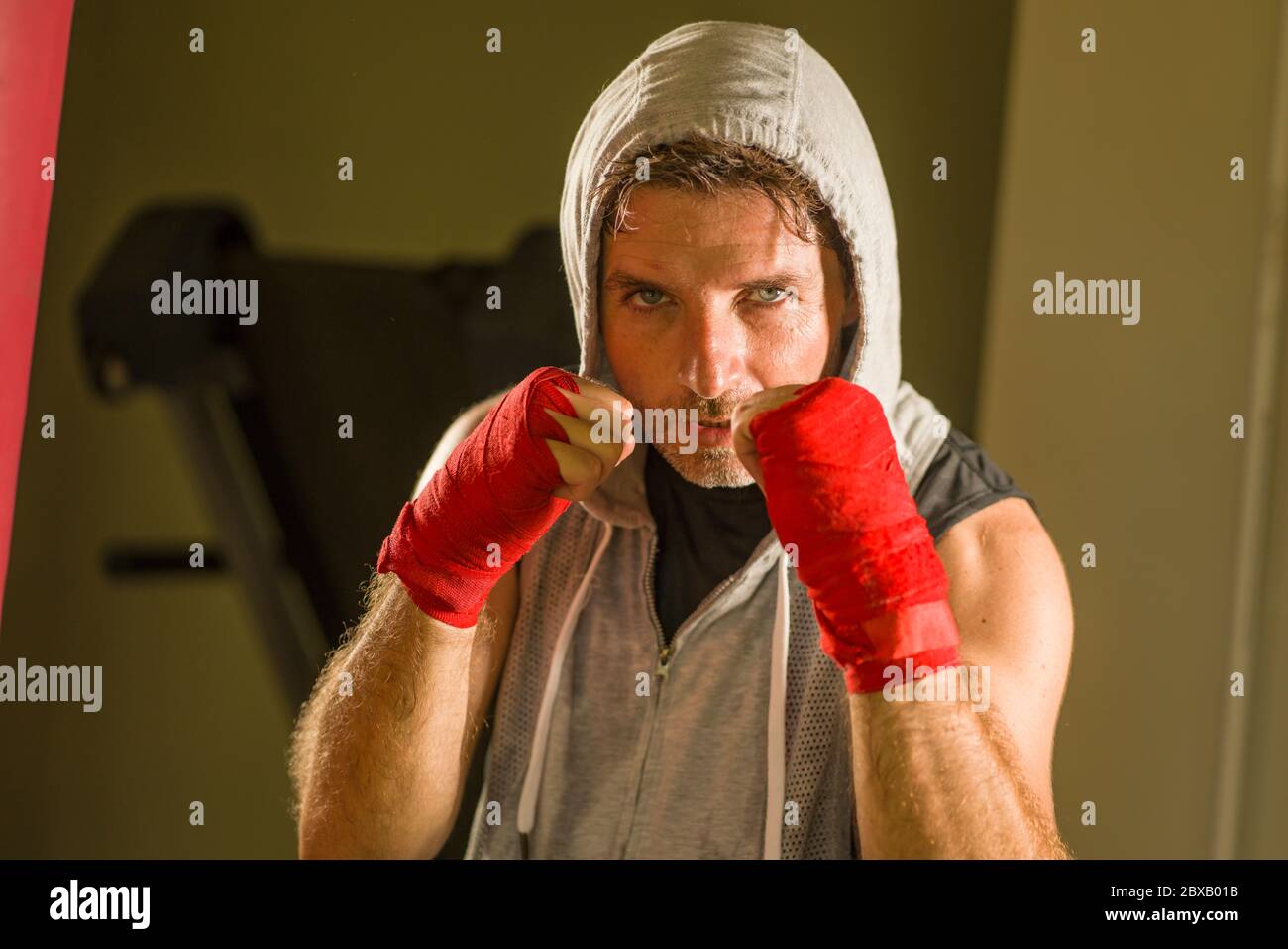 sport fitness lifestyle portrait of young tough and sweaty man boxing ...