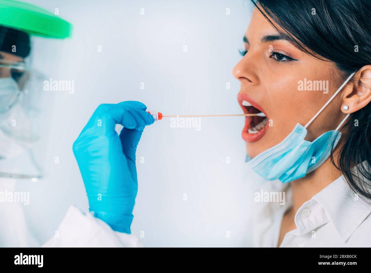 Medical worker taking swab for a coronavirus test Stock Photo - Alamy