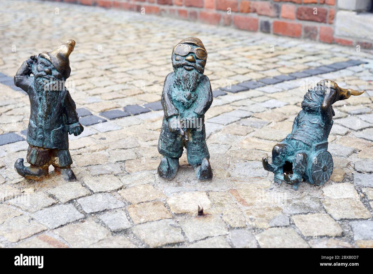 Wroclaw, Poland 06-24-2013 three little dwarf sculptures in the street ...