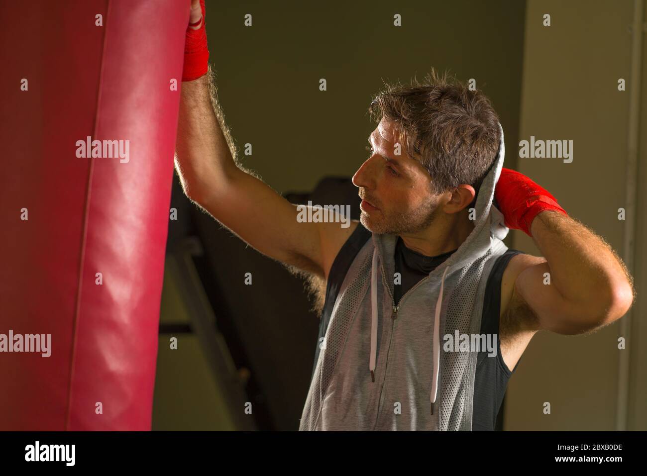 sport fitness lifestyle portrait of young tough and sweaty man boxing ...