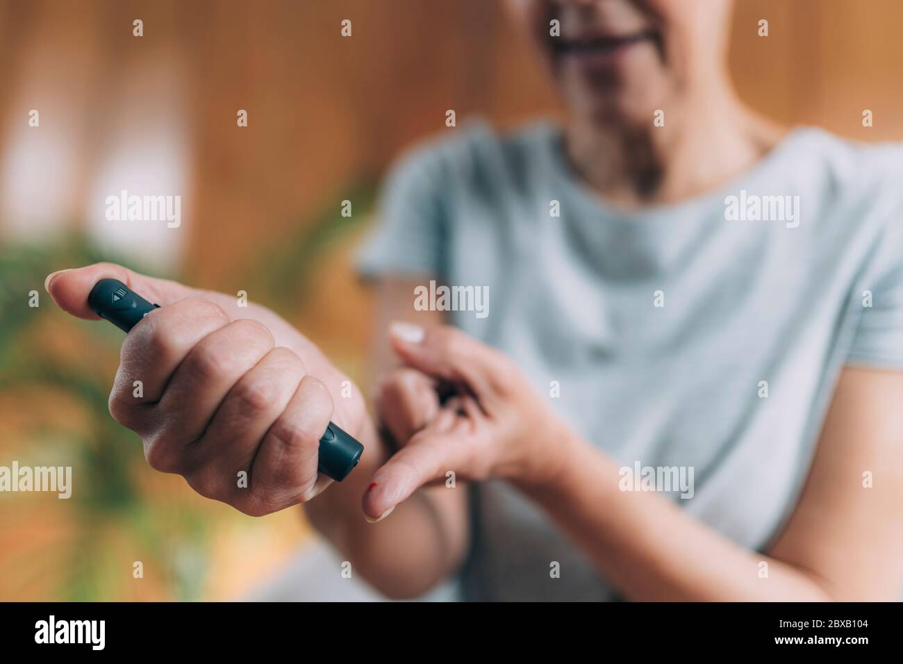 Blood sugar finger prick testing with portable glucometer Stock Photo ...