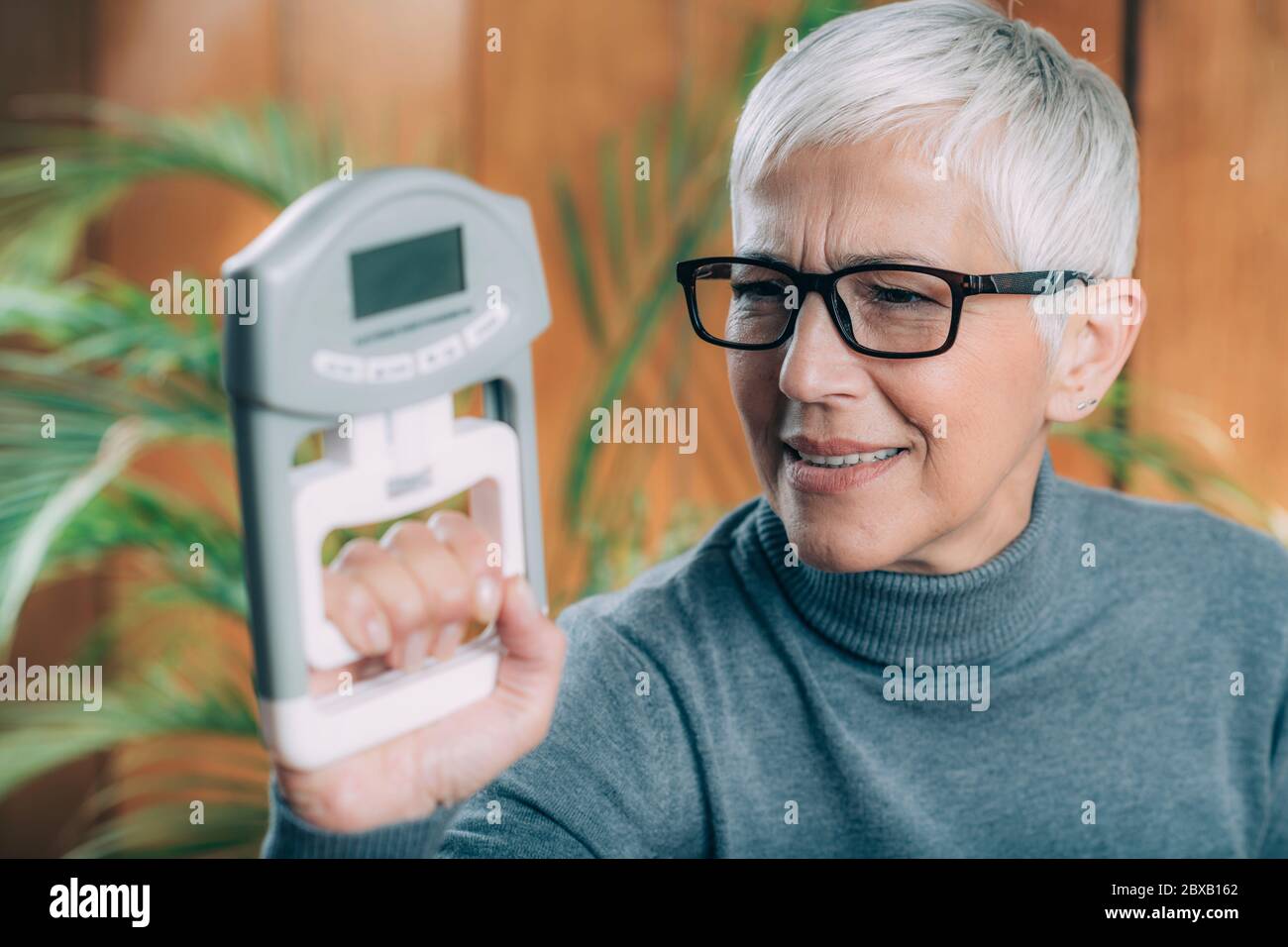 Using hand dynamometer for grip strength test Stock Photo - Alamy