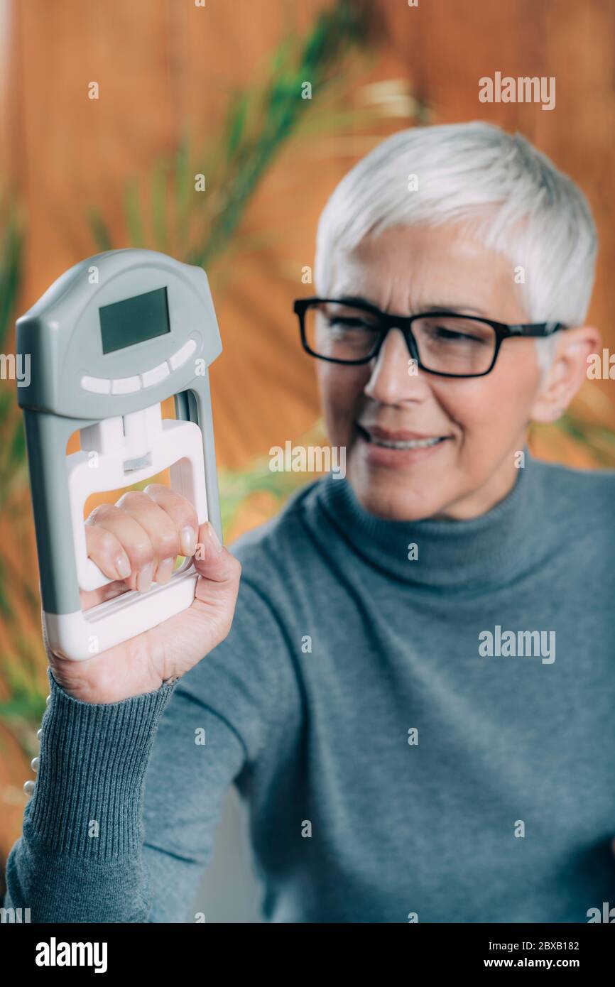 Using hand dynamometer for grip strength test Stock Photo - Alamy