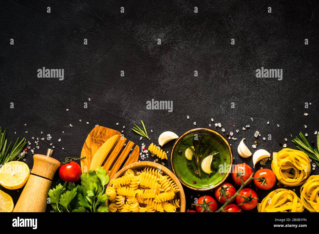 Food cooking background at black table top view Stock Photo - Alamy