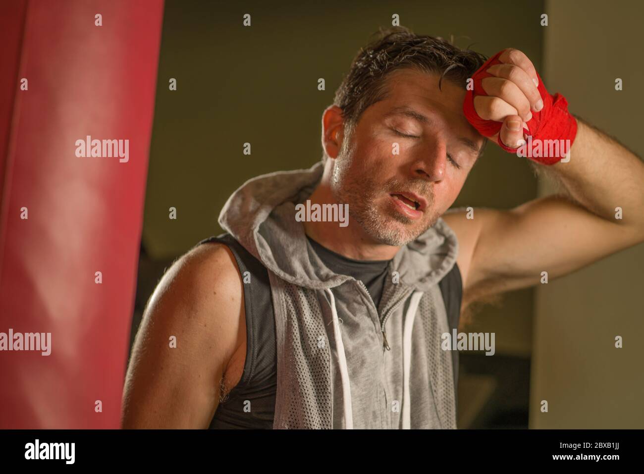 sport fitness lifestyle portrait of young tough and sweaty man boxing ...
