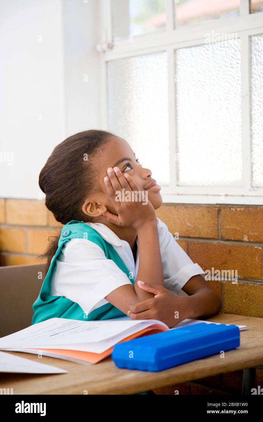 Girl staring out of classroom window hi-res stock photography and ...