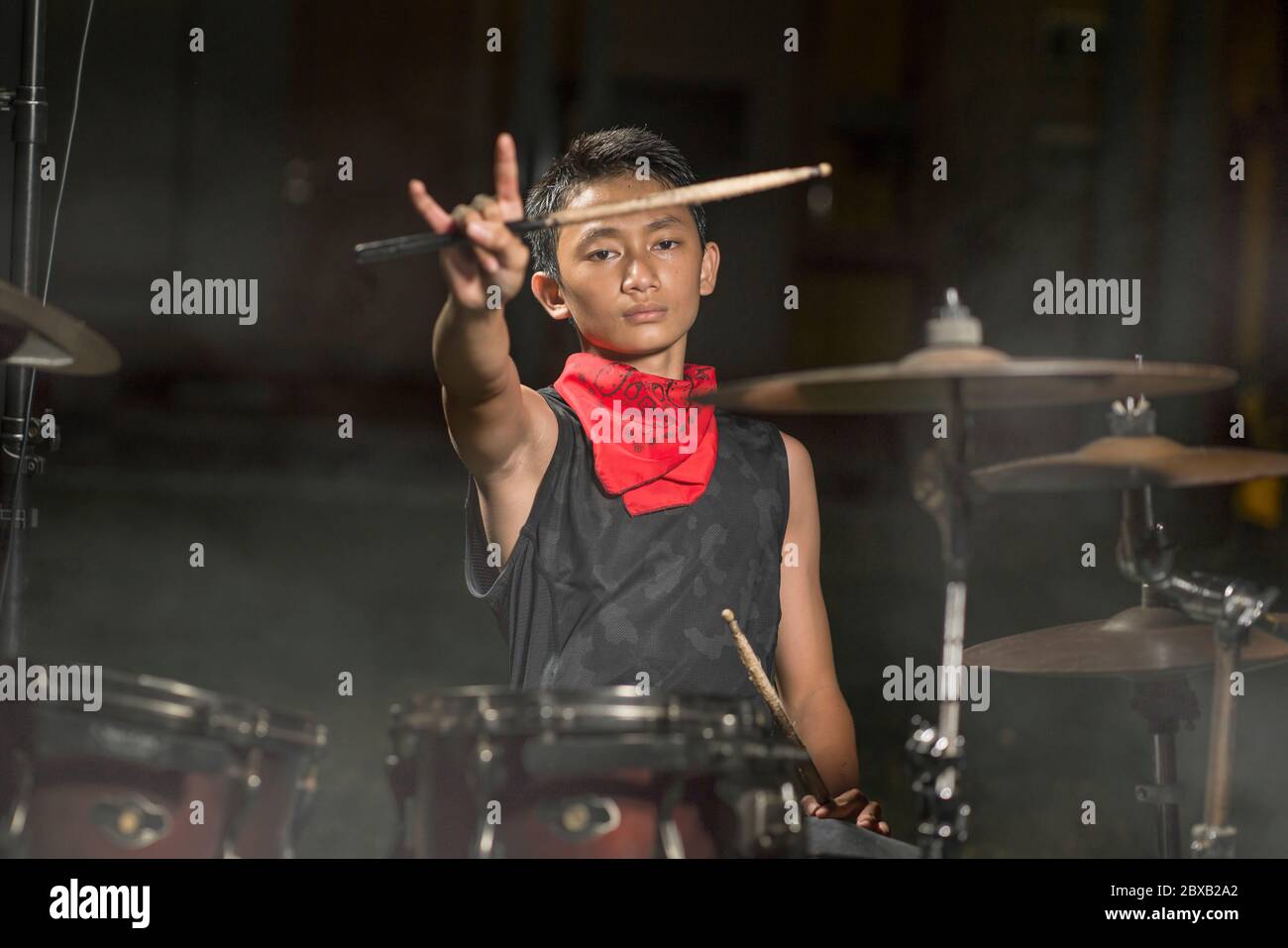 young boy as talented rock band drummer . Handsome and cool Asian ...