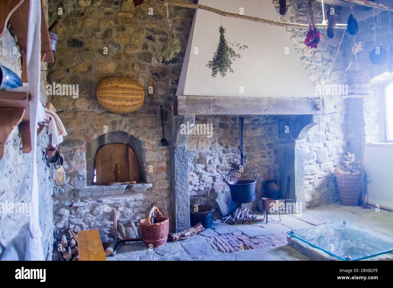 ancient stone fireplace of traditional kitchen blackened by fire and ...