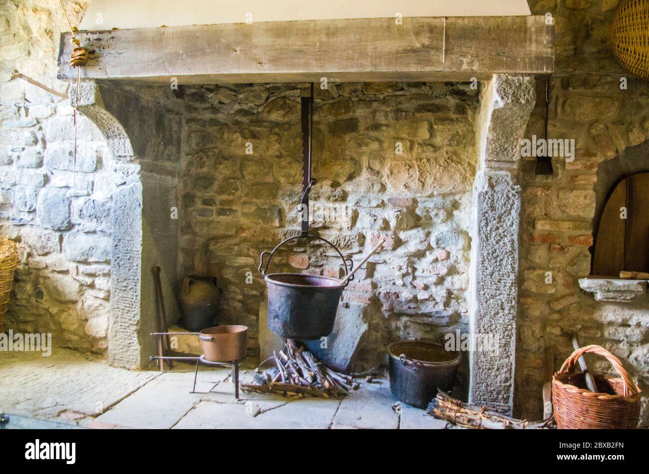 ancient stone fireplace of traditional kitchen blackened by fire and ...