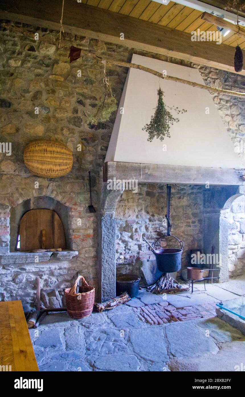 ancient stone fireplace of traditional kitchen blackened by fire and ...